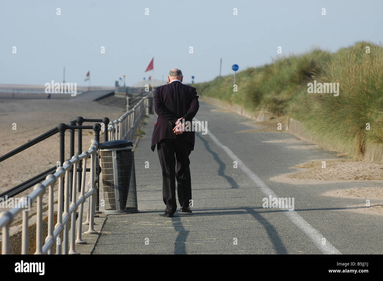 Man walking on promenade at Crosby, Merseyside, England, UK Stock Photo ...