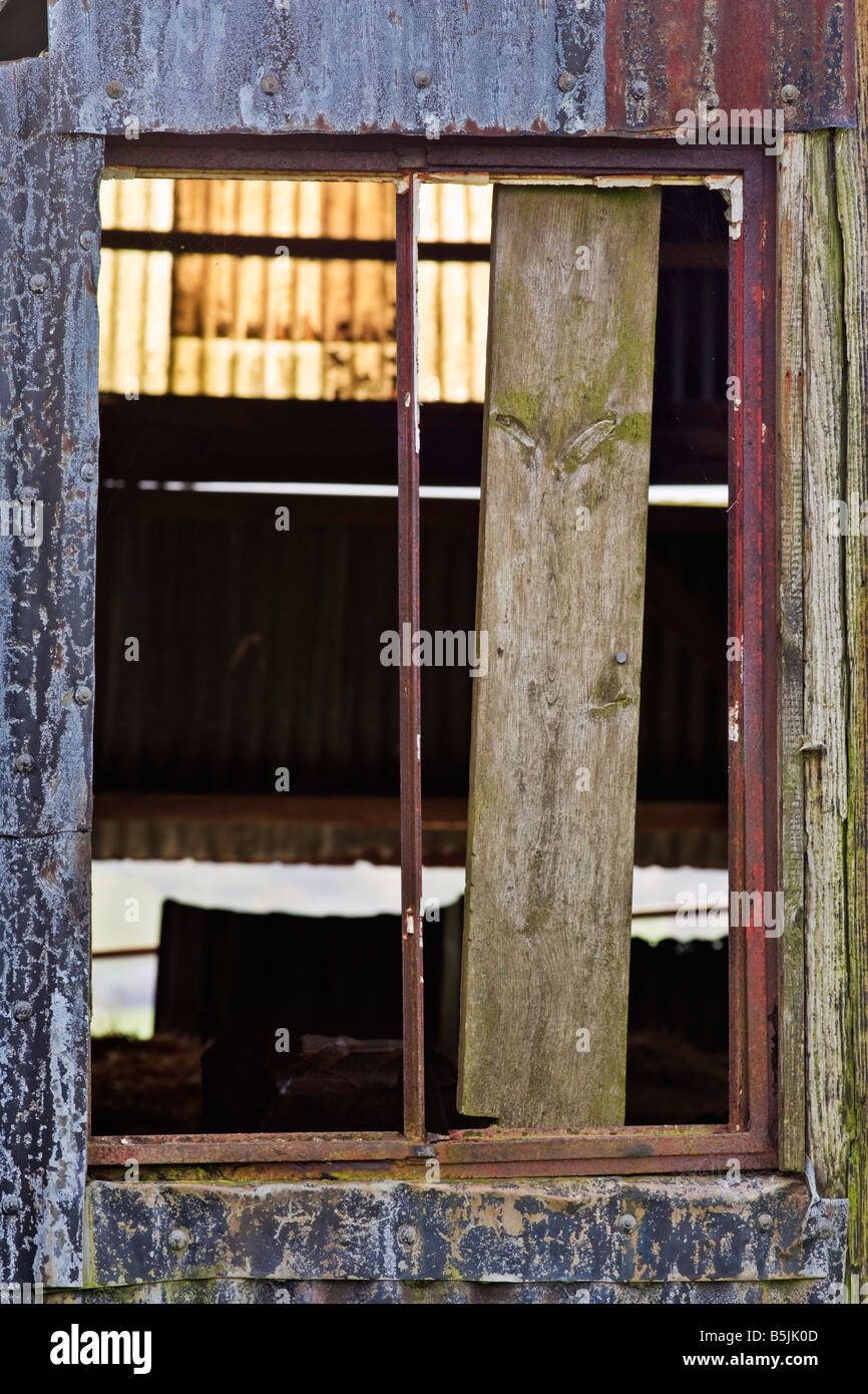 Close up of the windows of a farmer's run down old shed in a field near ...
