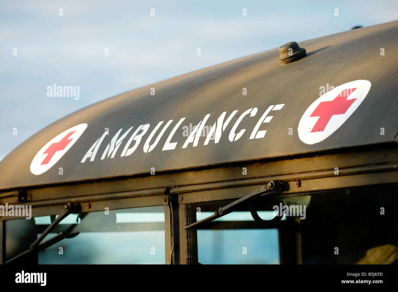 Ambulance text with symbolic red crosses on a historic military jeep ...