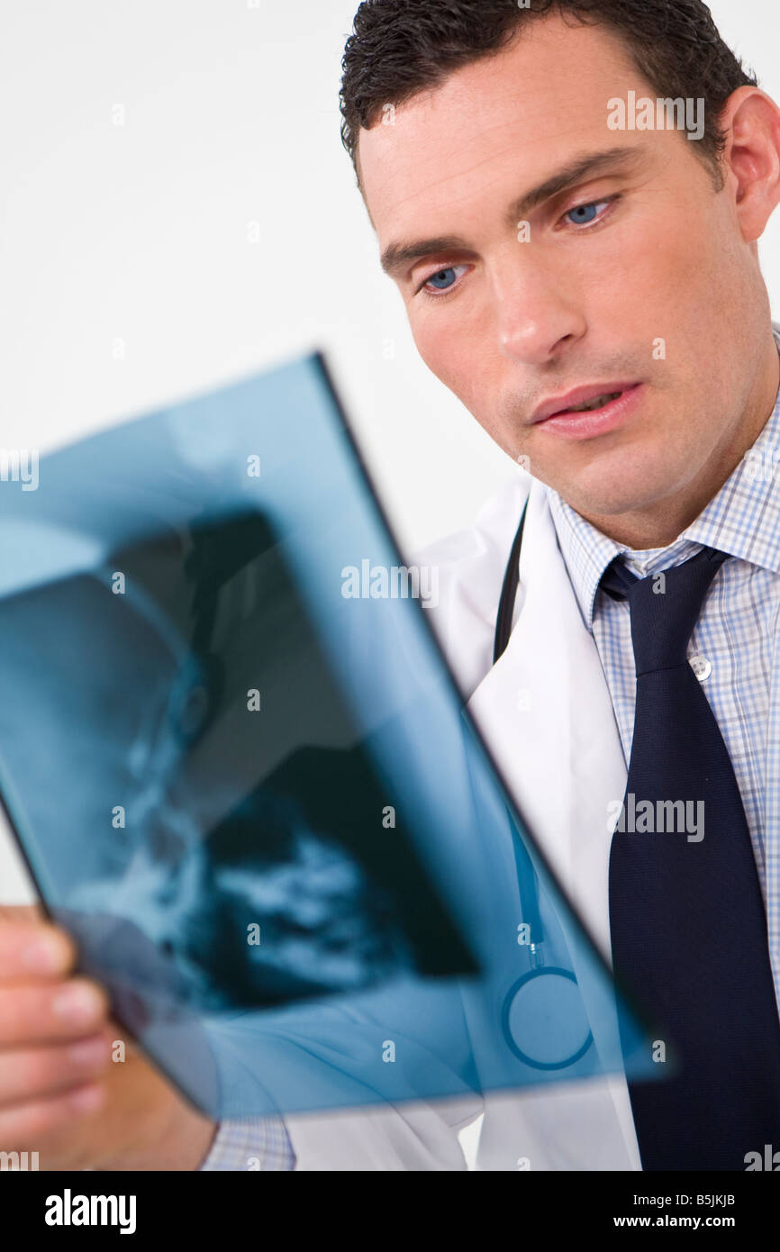 A male doctor examining an X ray of a human skull Stock Photo - Alamy