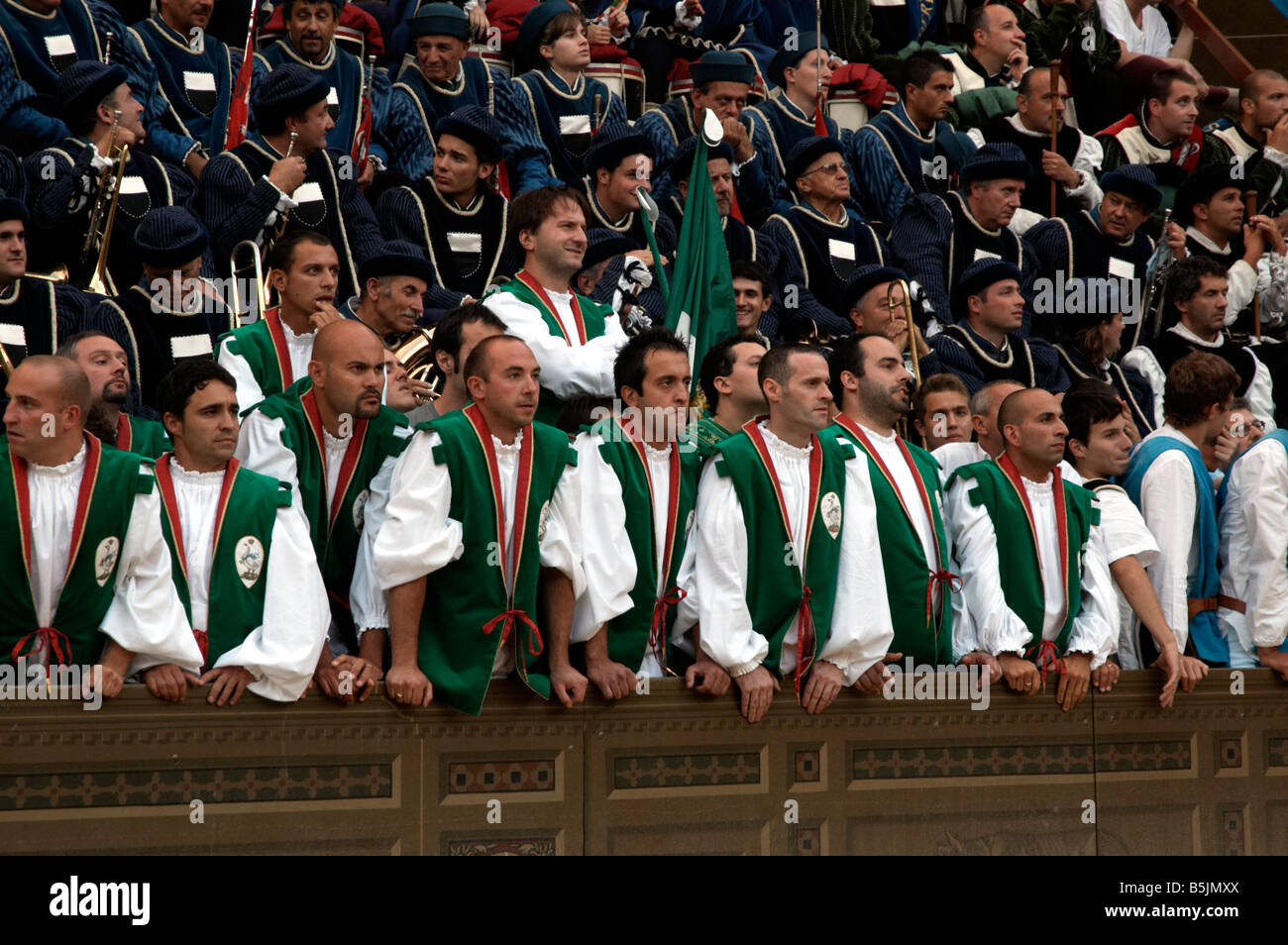 Sienese people dressed in medieval costume await the start of the Palio ...