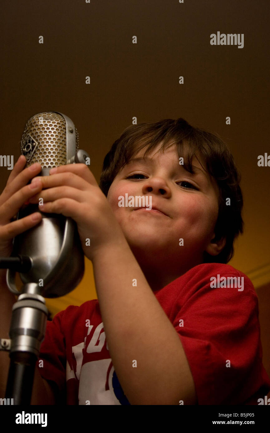 Young boy sings in an old microphone Stock Photo - Alamy