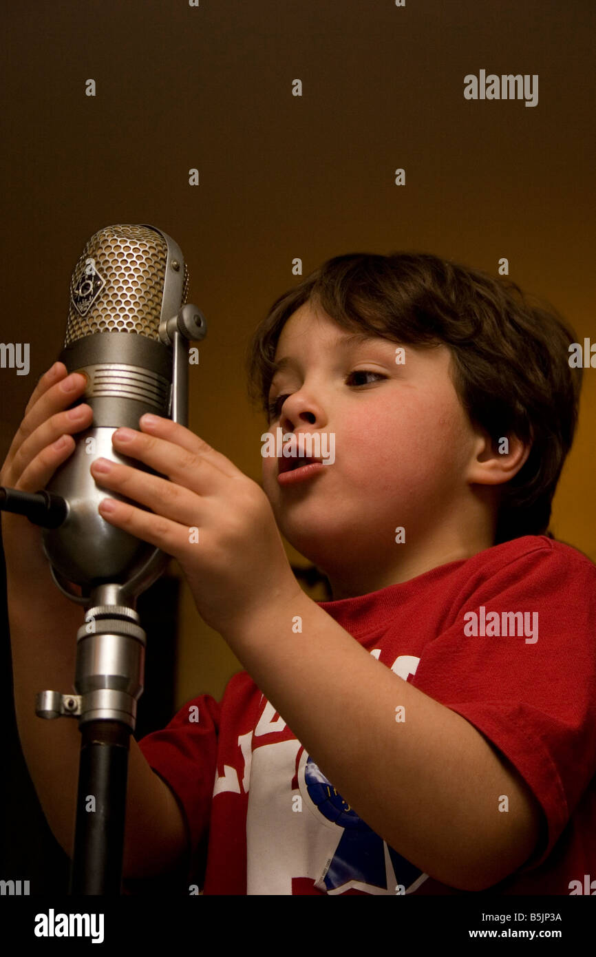 Young boy sings in an old microphone Stock Photo - Alamy