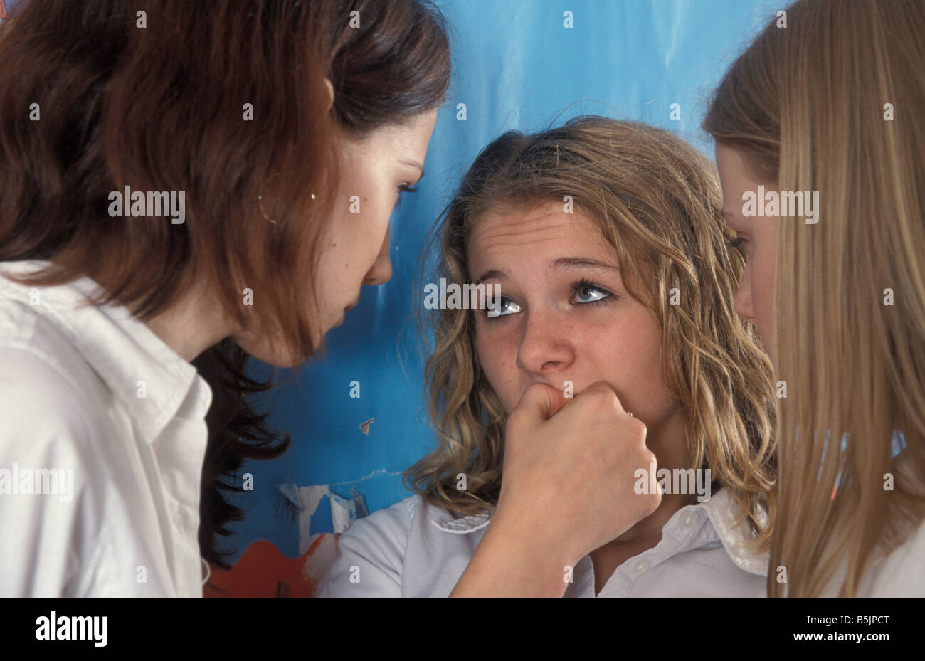 teenage girls bullying peer on school premises Stock Photo - Alamy
