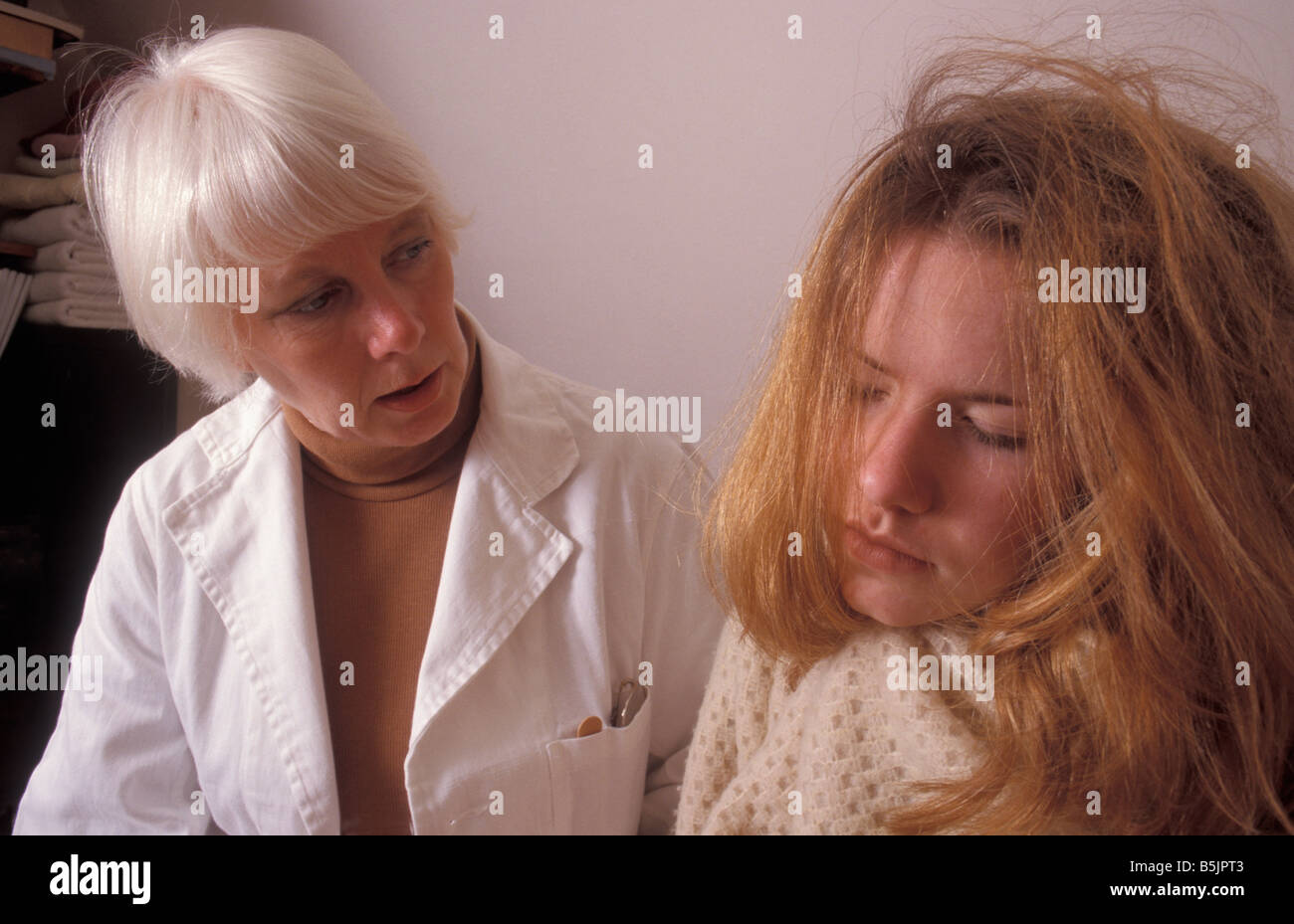 dishevelled teenage daughter with physician in hospital or clinic Stock ...