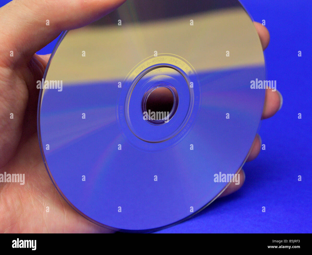 A hand holding a CD Stock Photo - Alamy