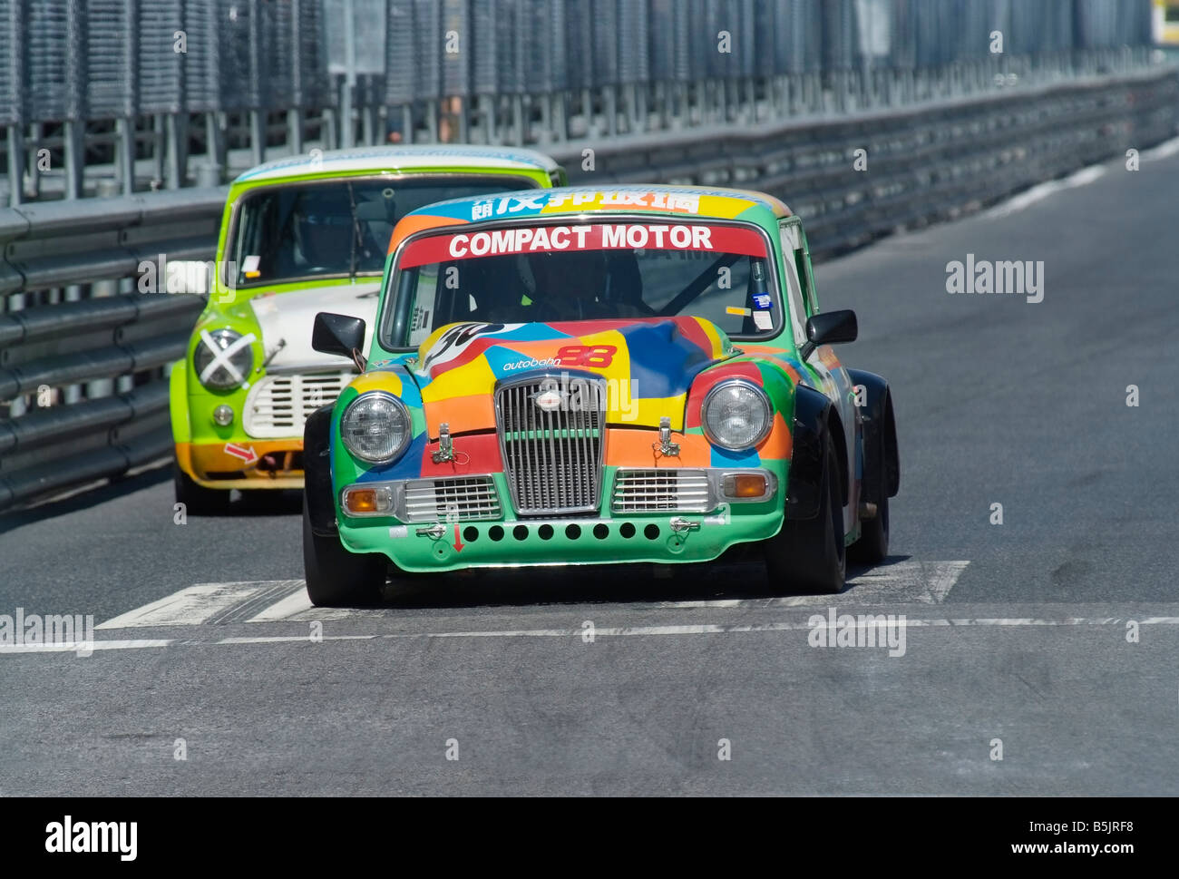 Colourful Wolseley Hornet and green Mini racing at the city circuit of ...