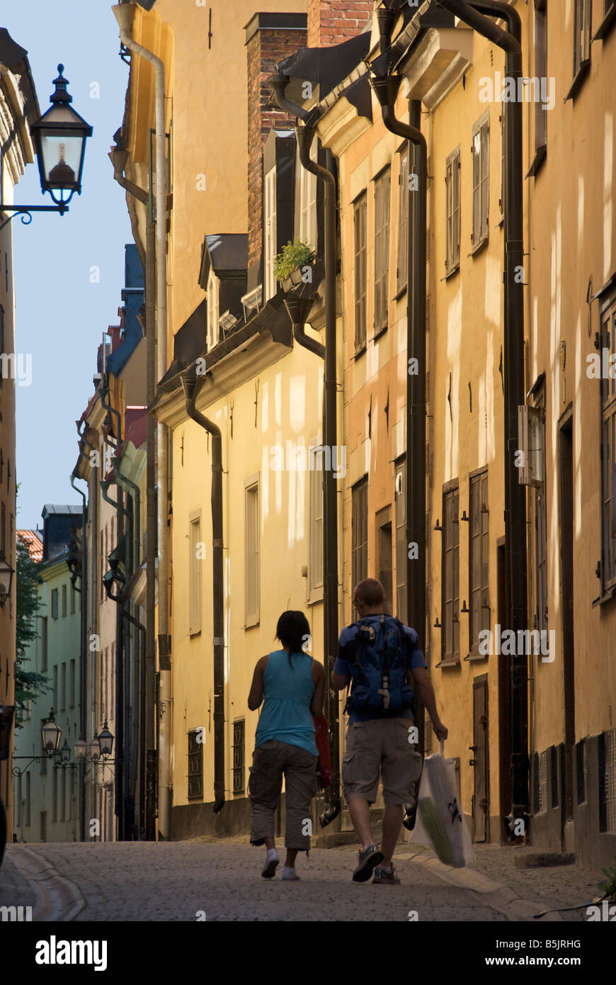 Two people walking home Prastgaten Gamla Stan Stockholm Sweden Stock ...