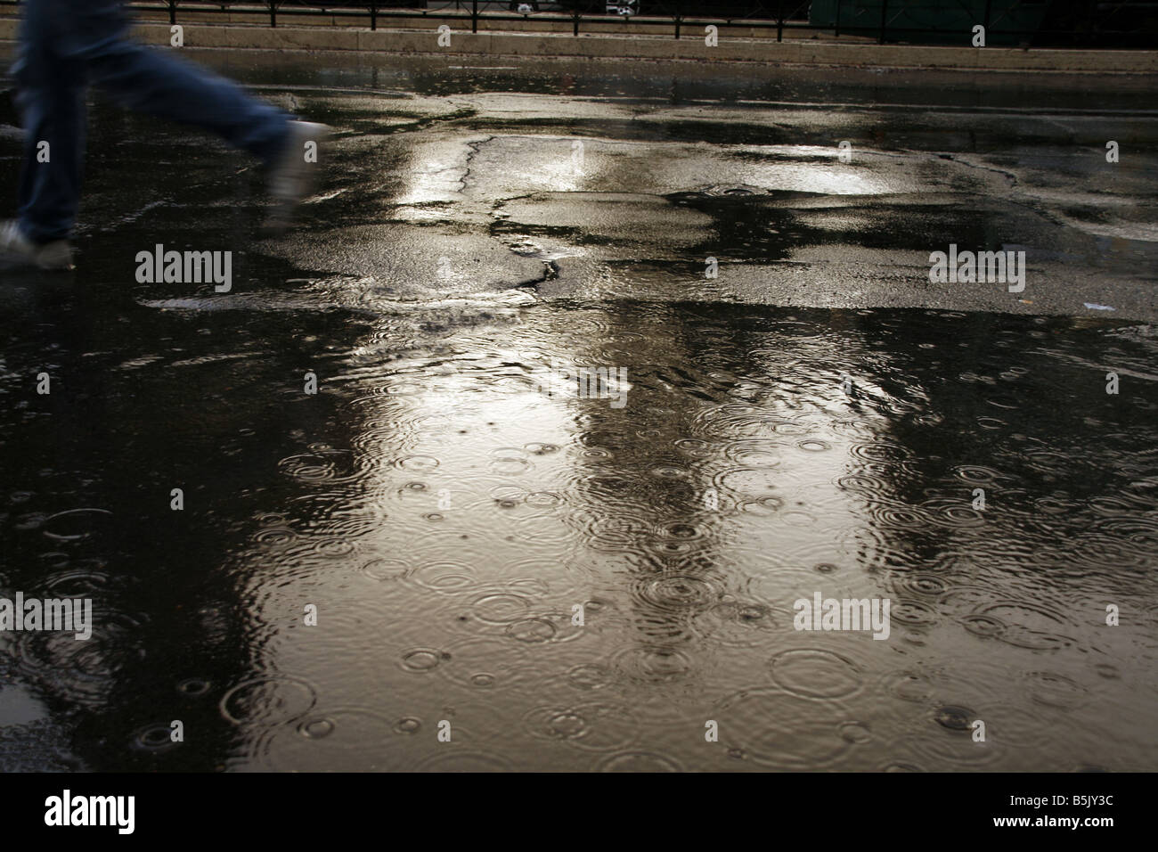 lots rain drops falling in water puddle in street Stock Photo - Alamy