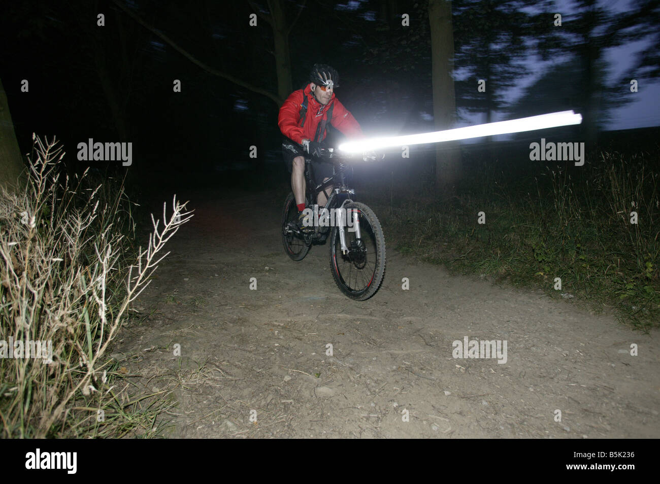 A man riding a mountain bike at night Stock Photo - Alamy