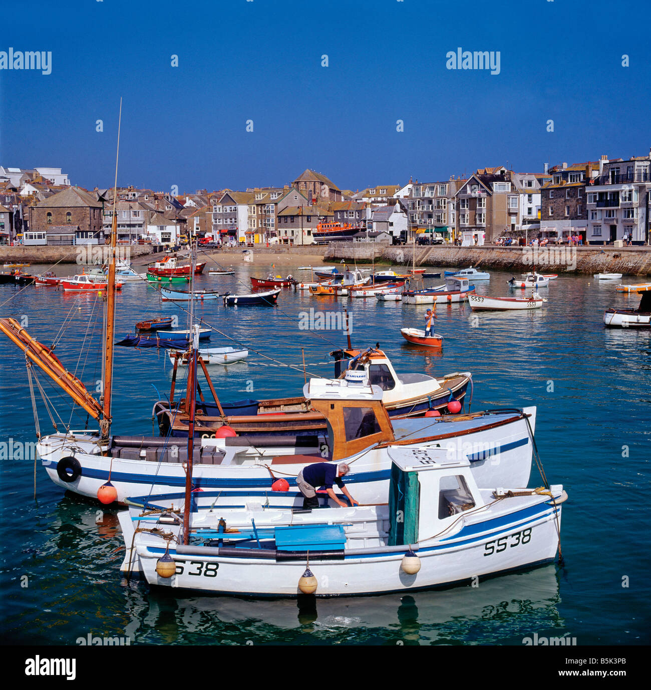Harbour scene with white fishing boats Stock Photo - Alamy