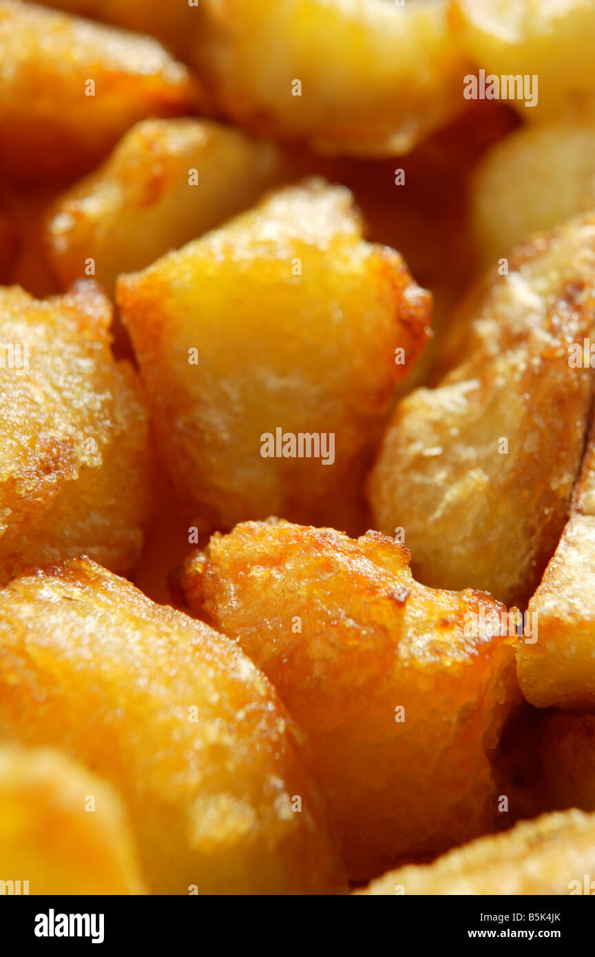 upright portrait Crispy roast potatoes piled together in a roasting tin ...