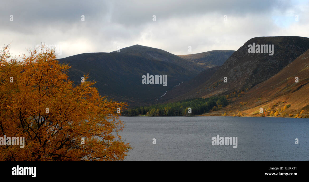a late autumn afternoon provides a dramatic backdrop to Loch Muick near ...