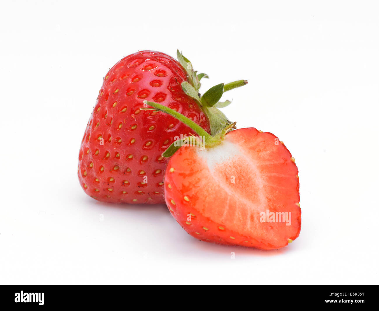An arrangement of a whole Strawberry and half of one Stock Photo - Alamy