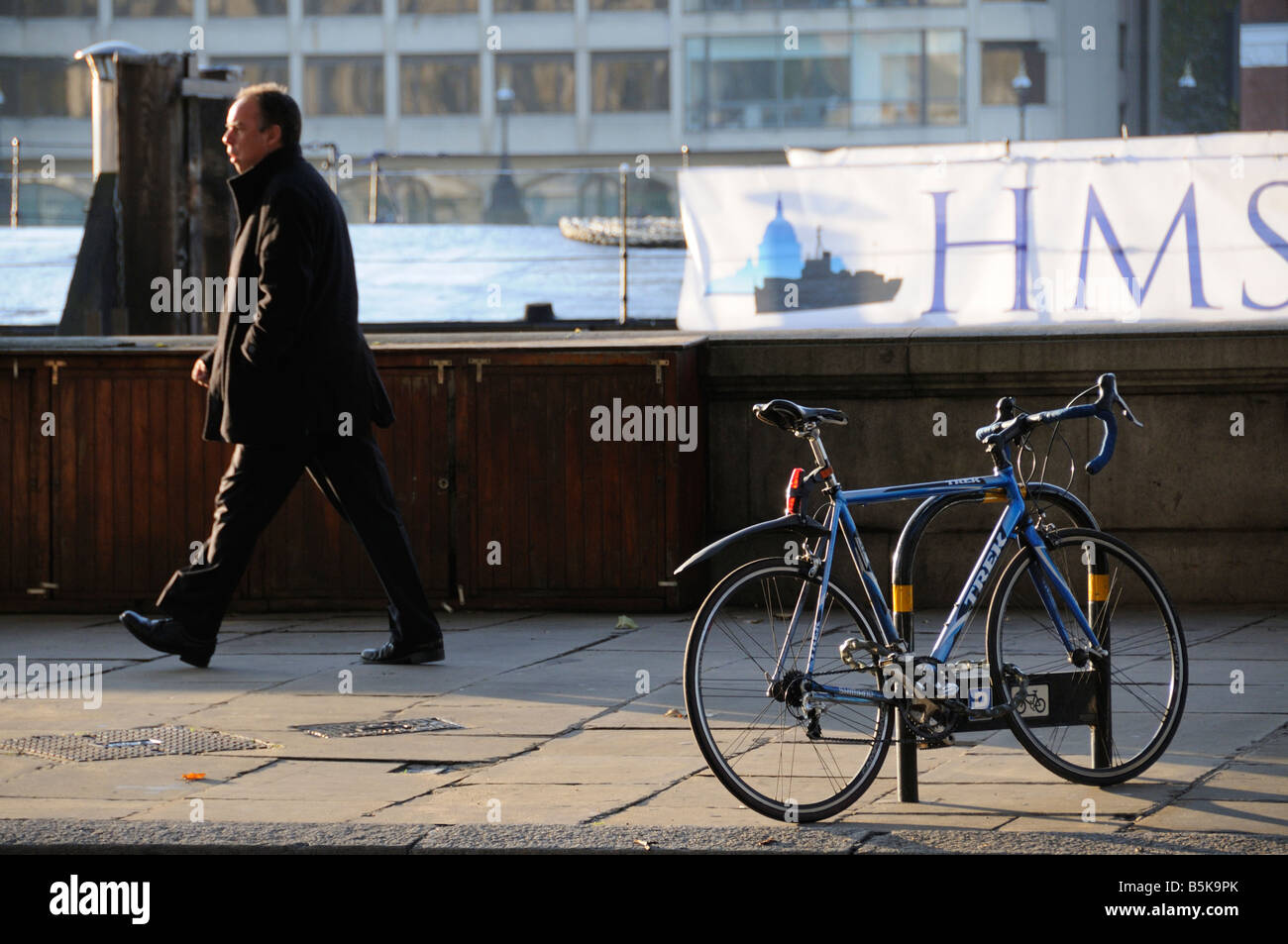 A man walking past a bicycle, Victoria Embankment, London, UK Stock ...