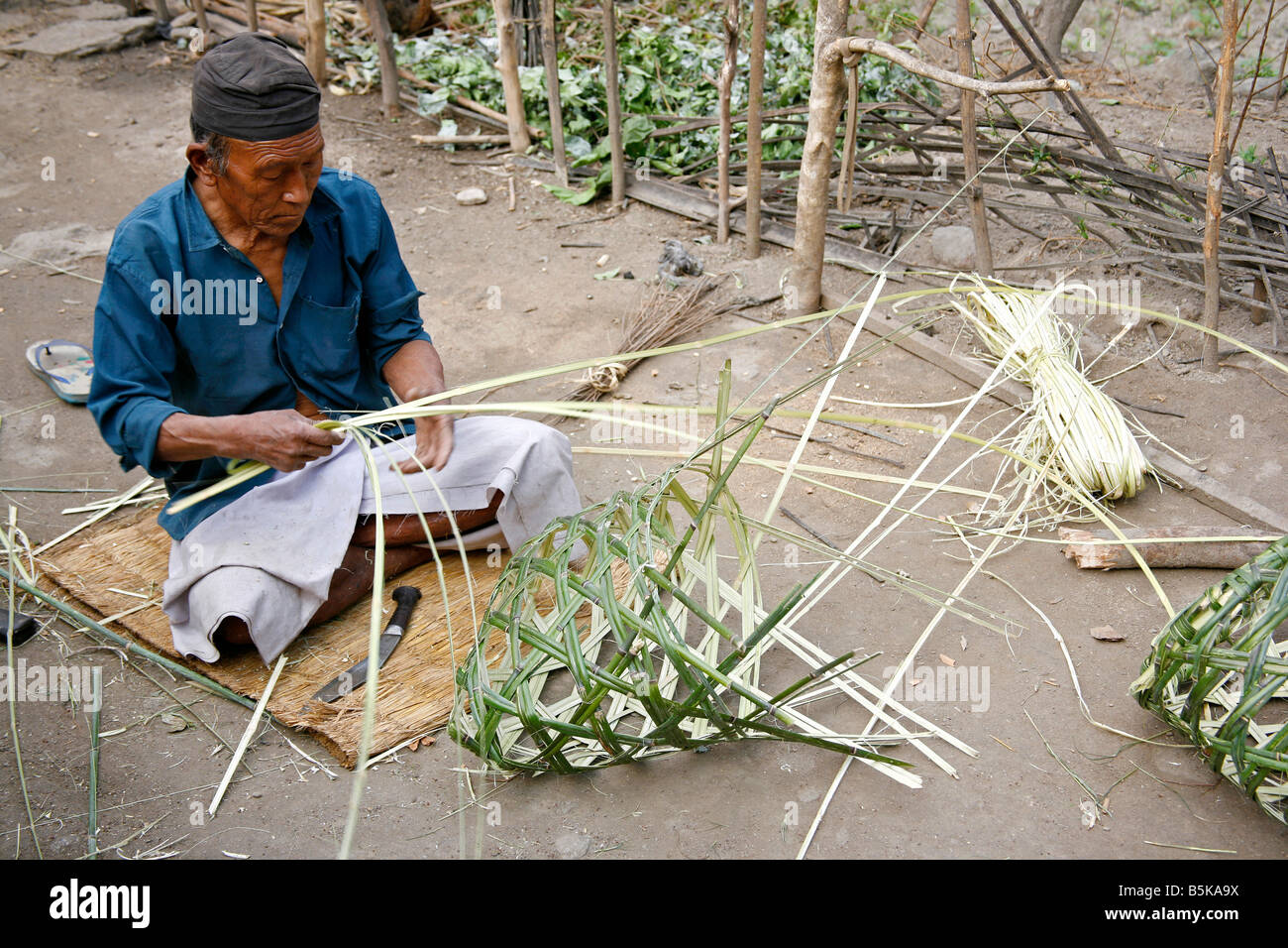 March 2008 Annapurna Nepal Traditional gurung man weaving baskets on ...