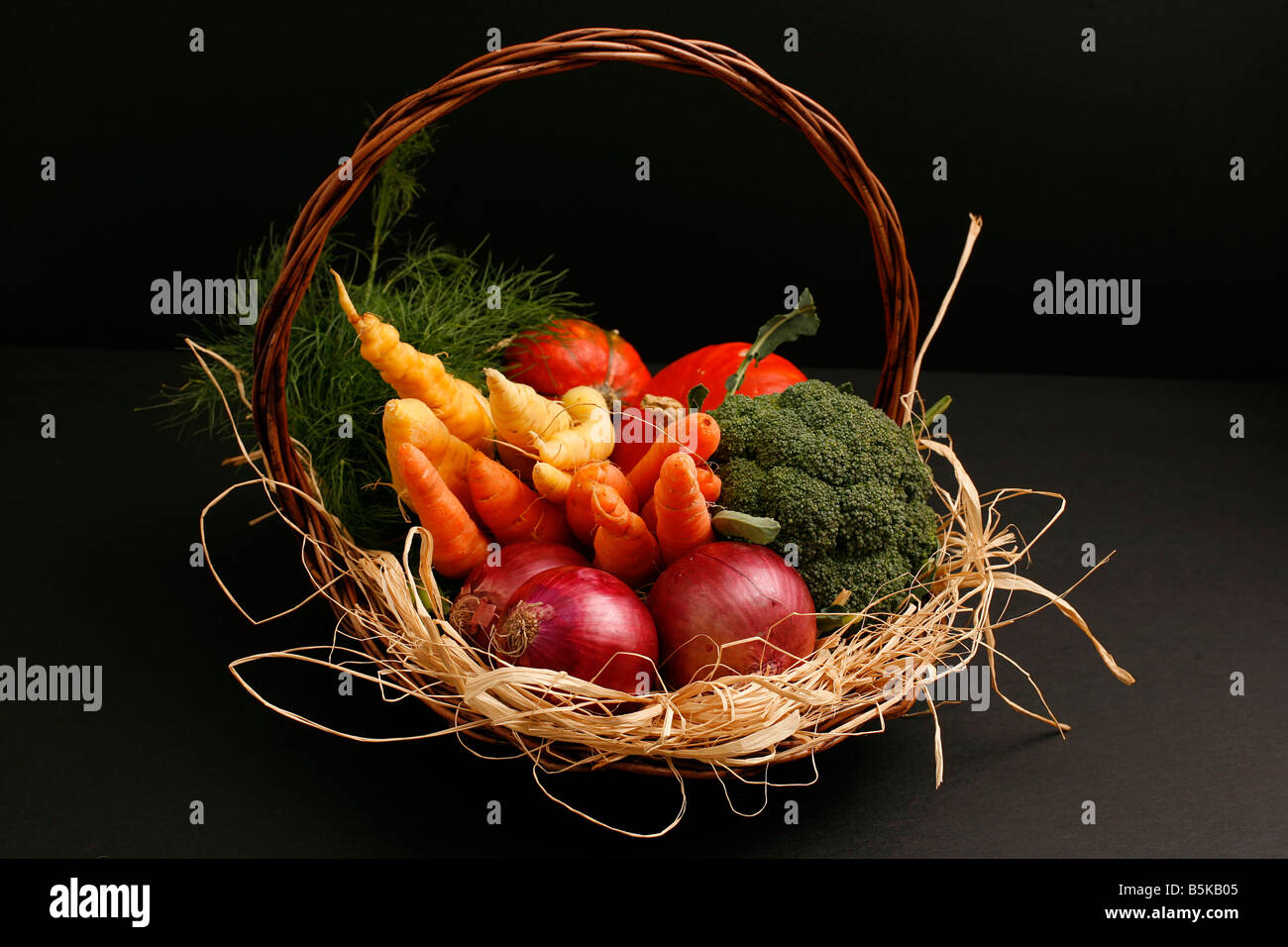 Mixed vegetable basket display on black background Stock Photo - Alamy