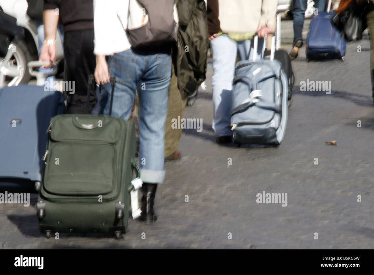 Woman pulling heavy luggage hi-res stock photography and images - Alamy