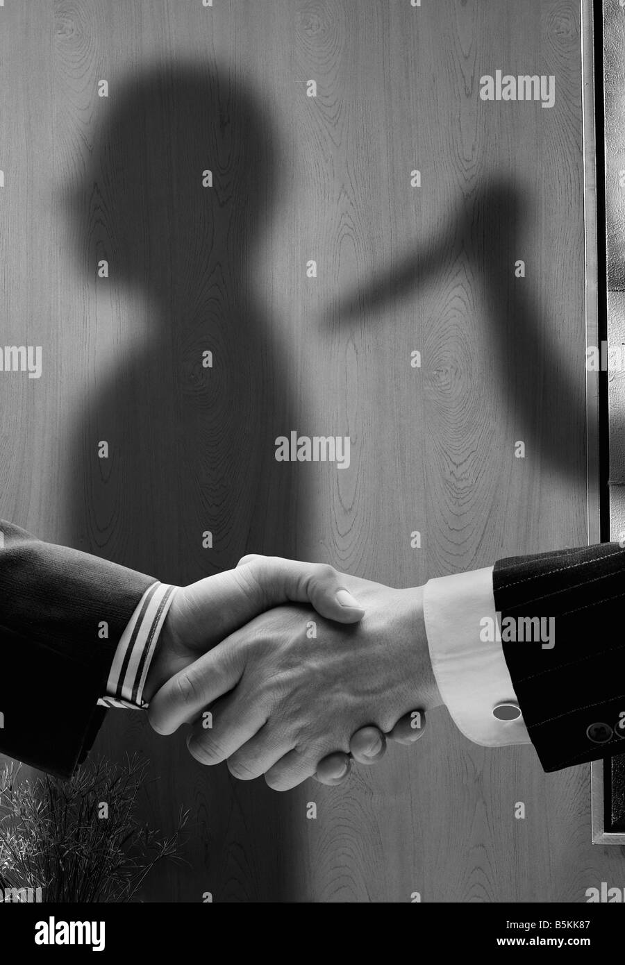 business handshake with shadows behind showing real intentions showing ...
