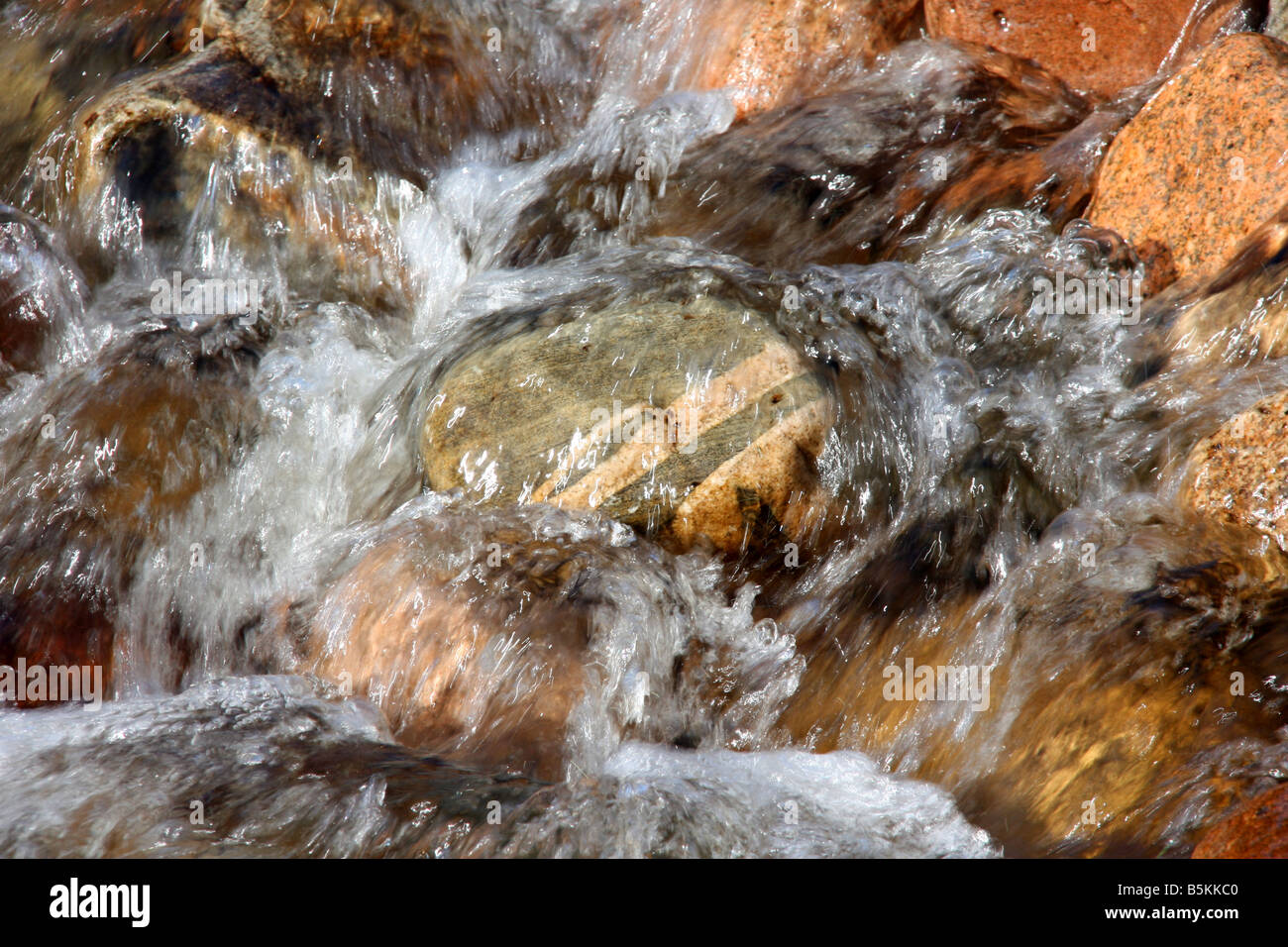 Water flowing over stones in river Stock Photo - Alamy