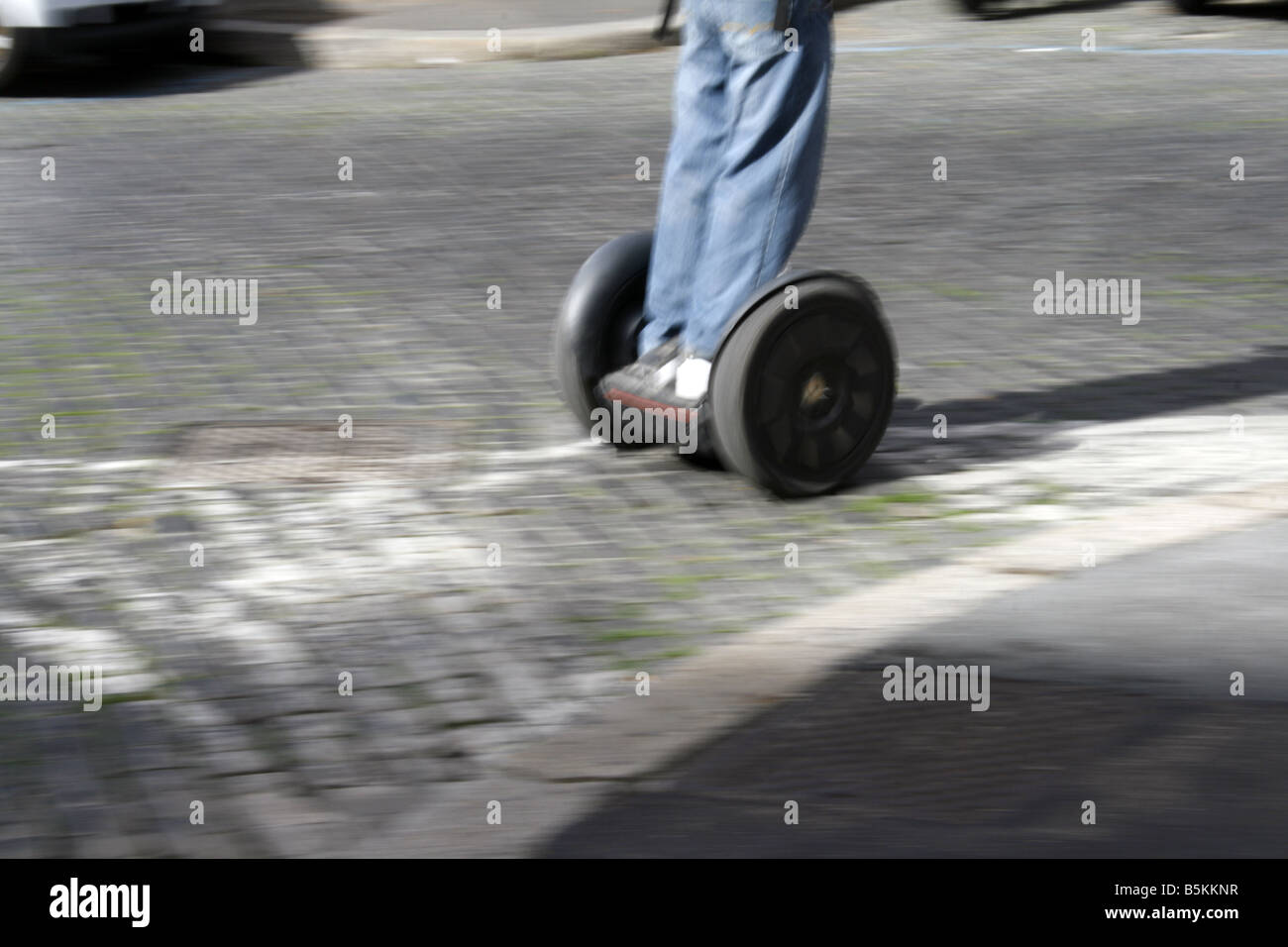 person riding segway personal transporter on street in town Stock Photo ...