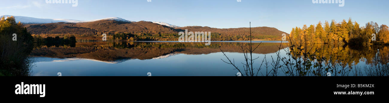 Panorama of Loch Alvie showing Autmn colours and calm reflection of ...