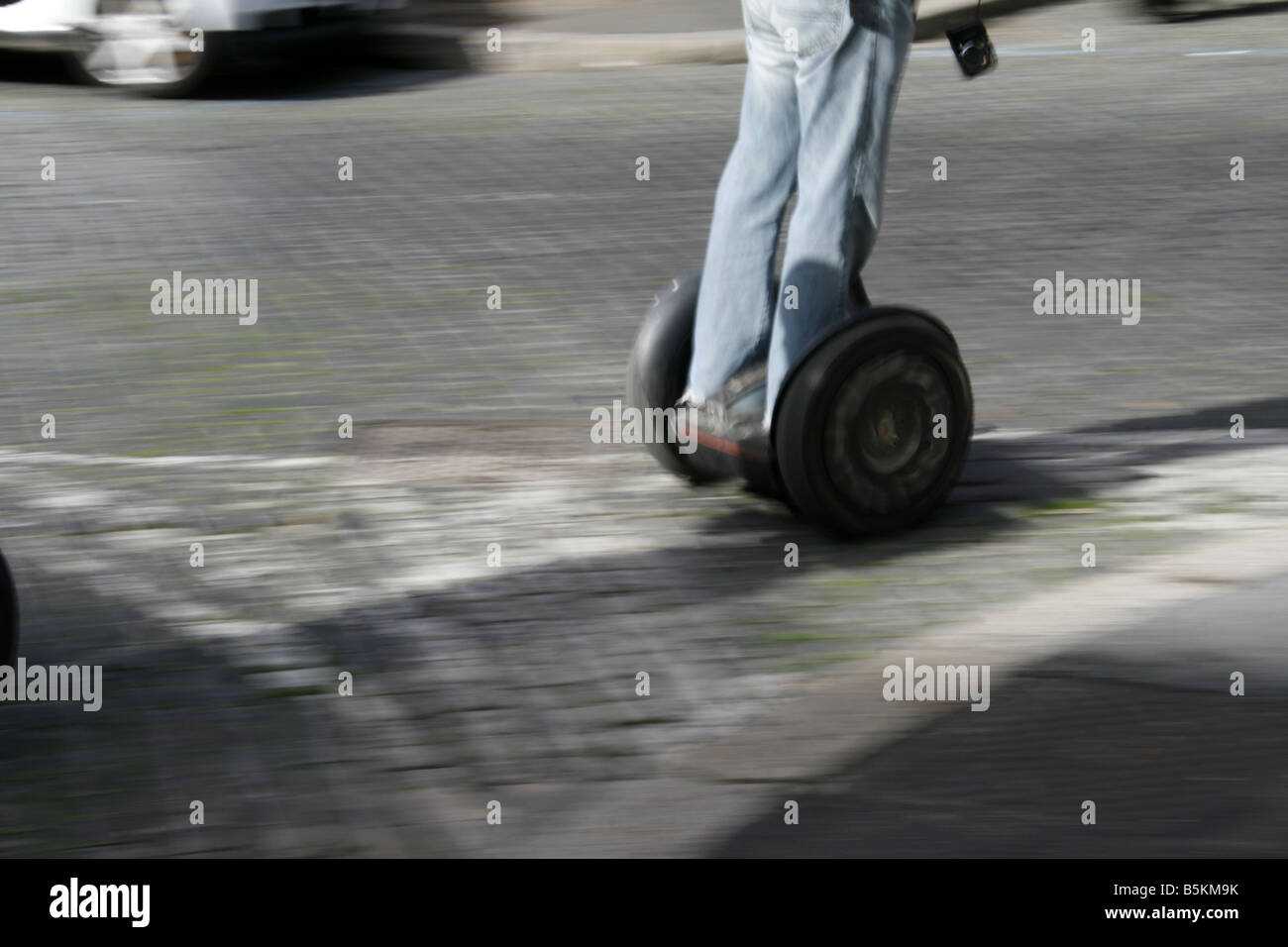 person riding segway personal transporter on street in town Stock Photo ...