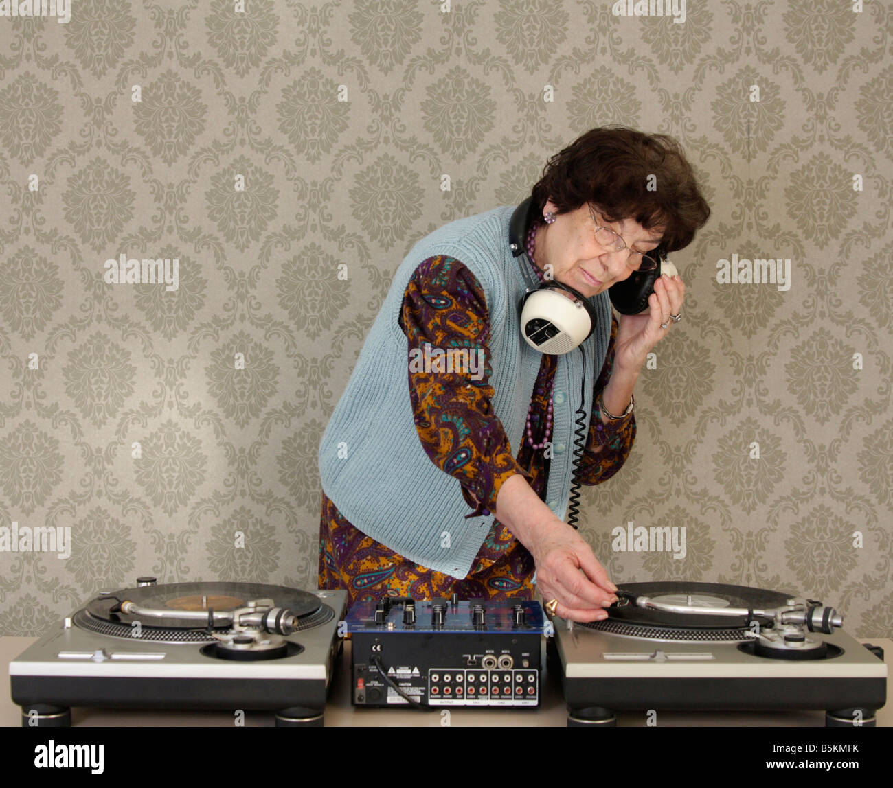 a very funky elderly granny dj go lady Stock Photo - Alamy