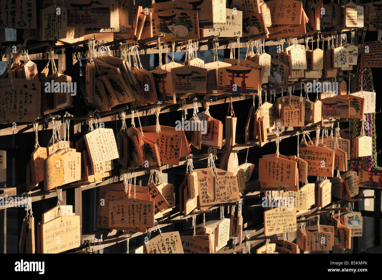 Wooden Ema showing visitors wishes and the Torii at Itsukushima Shrine ...