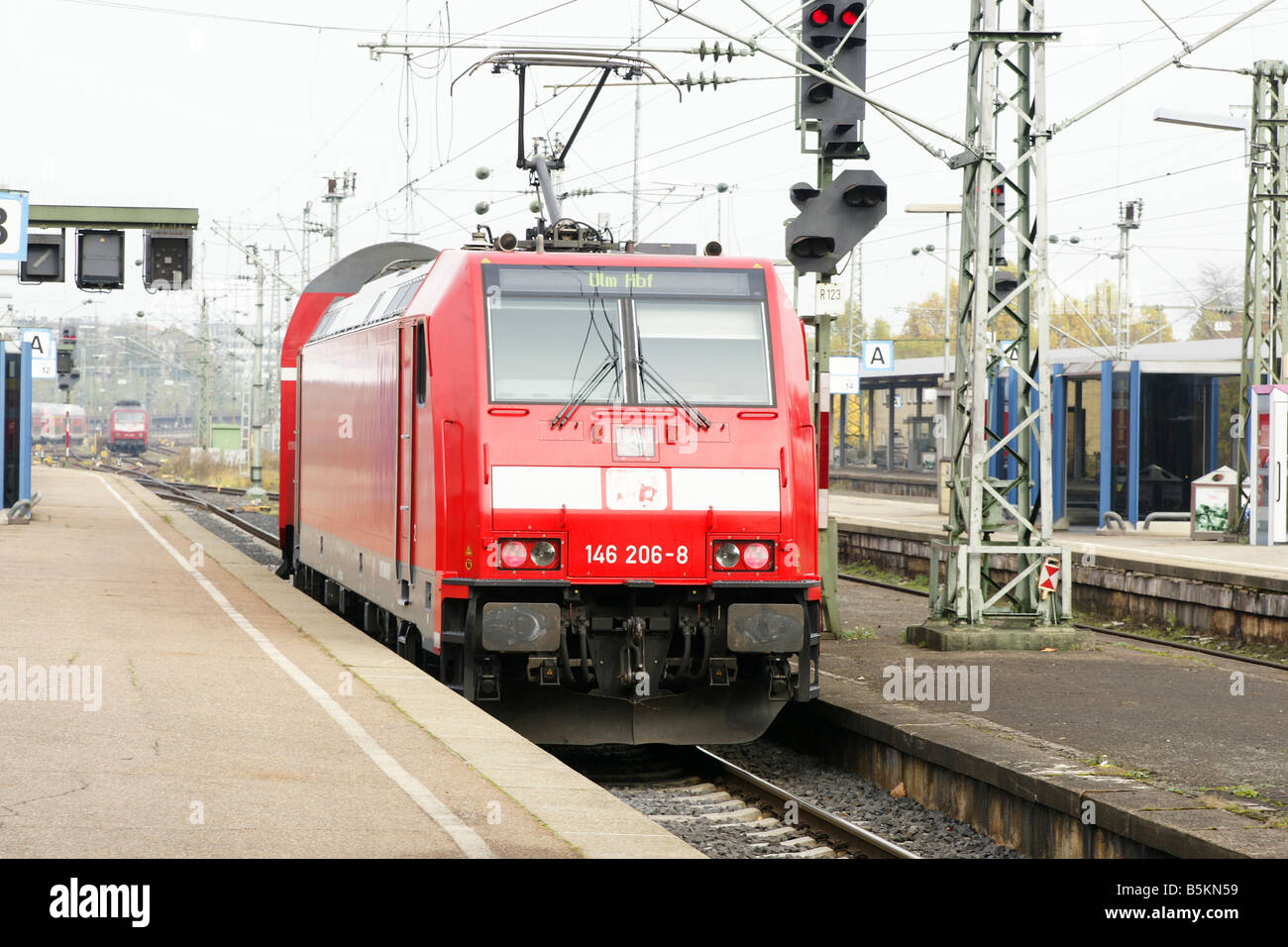 German red commuter train entering station Stock Photo - Alamy