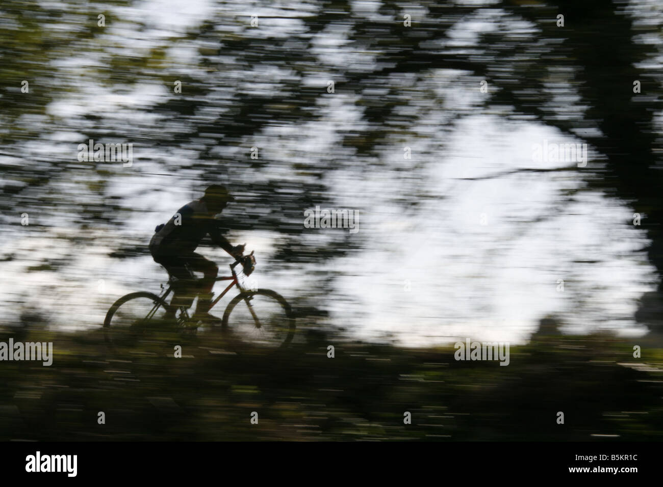 person riding fast bike on rural lane countryside Stock Photo - Alamy