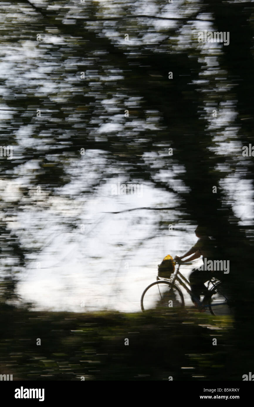 person riding fast bike on rural lane countryside Stock Photo - Alamy