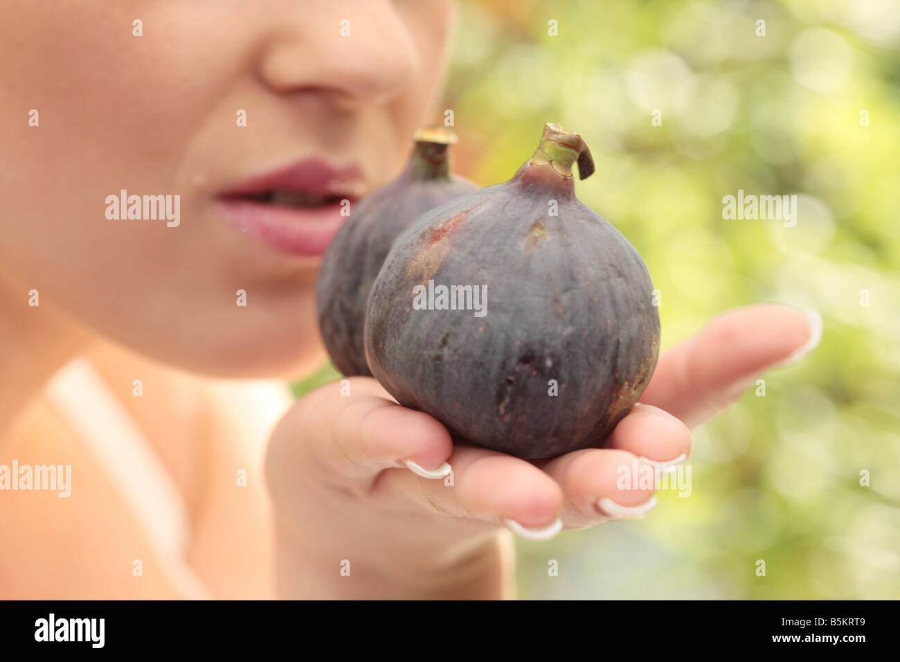 Young Woman Holding Two Figs Model Released Stock Photo - Alamy