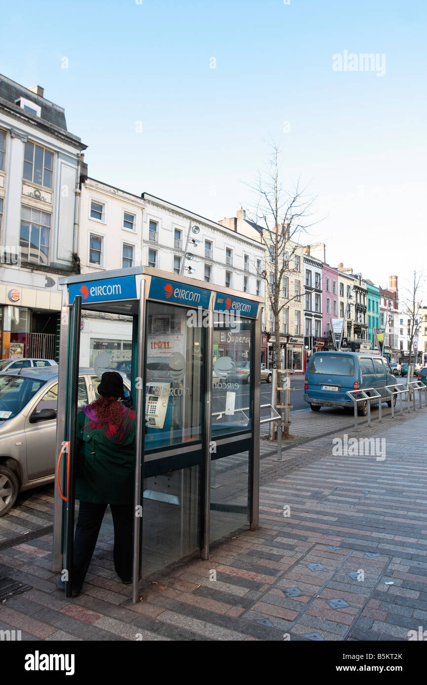 Woman using a public telephone Stock Photo - Alamy