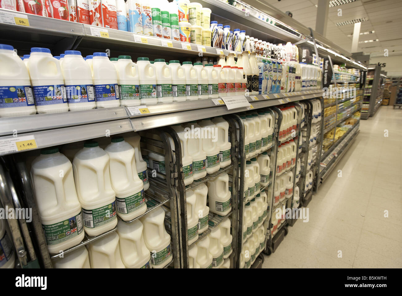 Milk stacked on supermarket shelf Stock Photo - Alamy