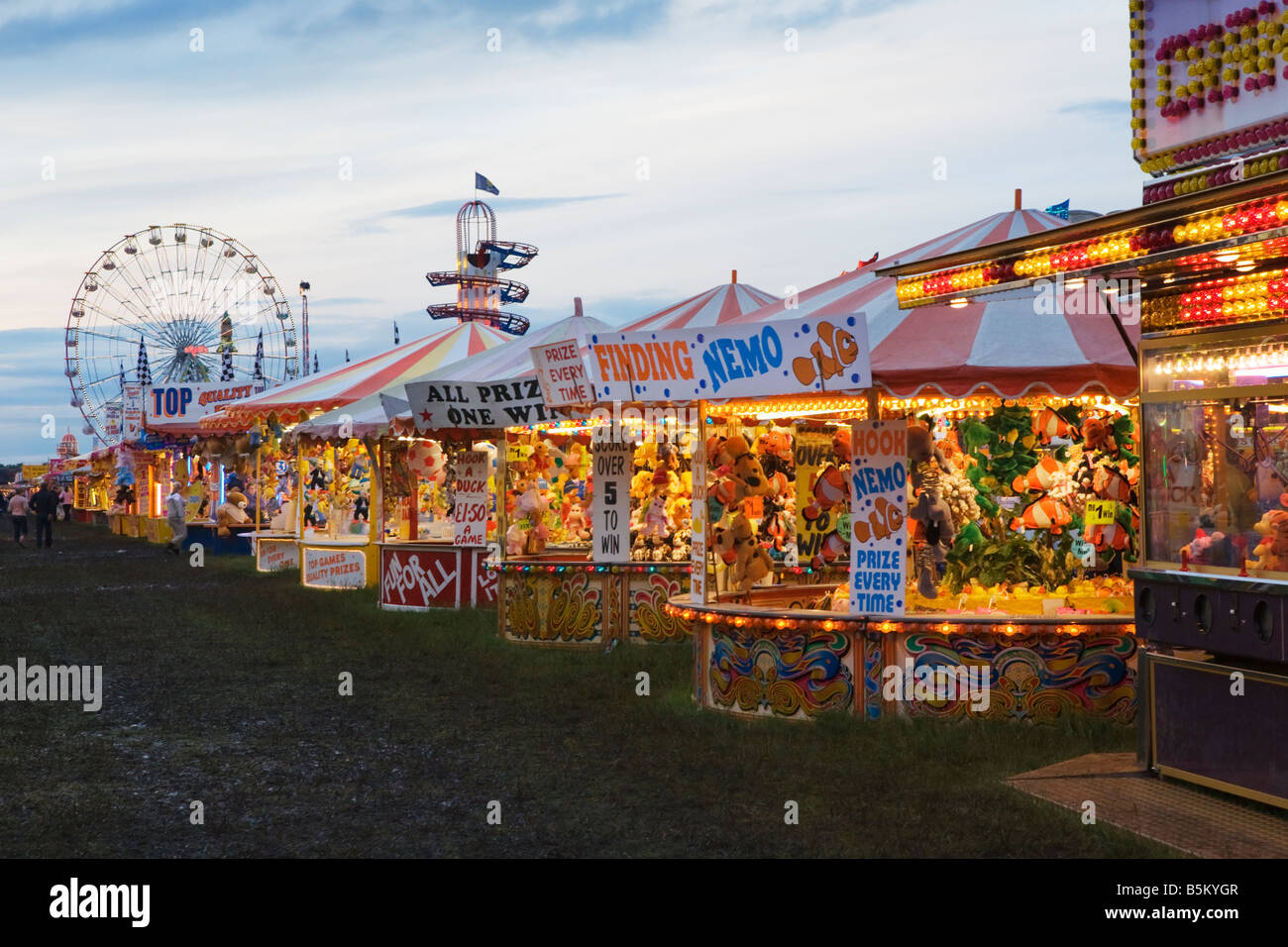 Game stalls and rides at a funfair (specifically at The Hoppings ...