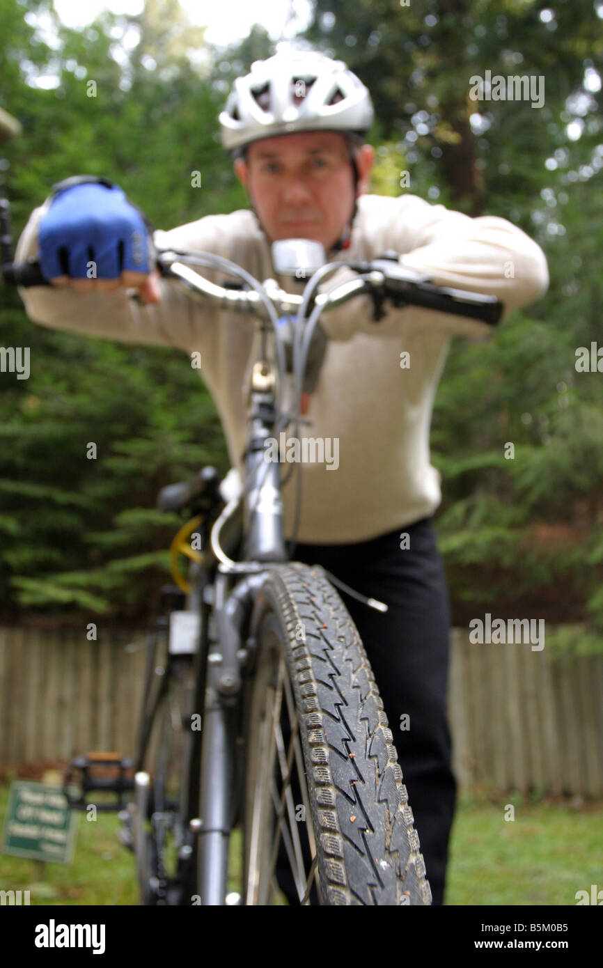 male commuter leaning on bicycle Stock Photo - Alamy