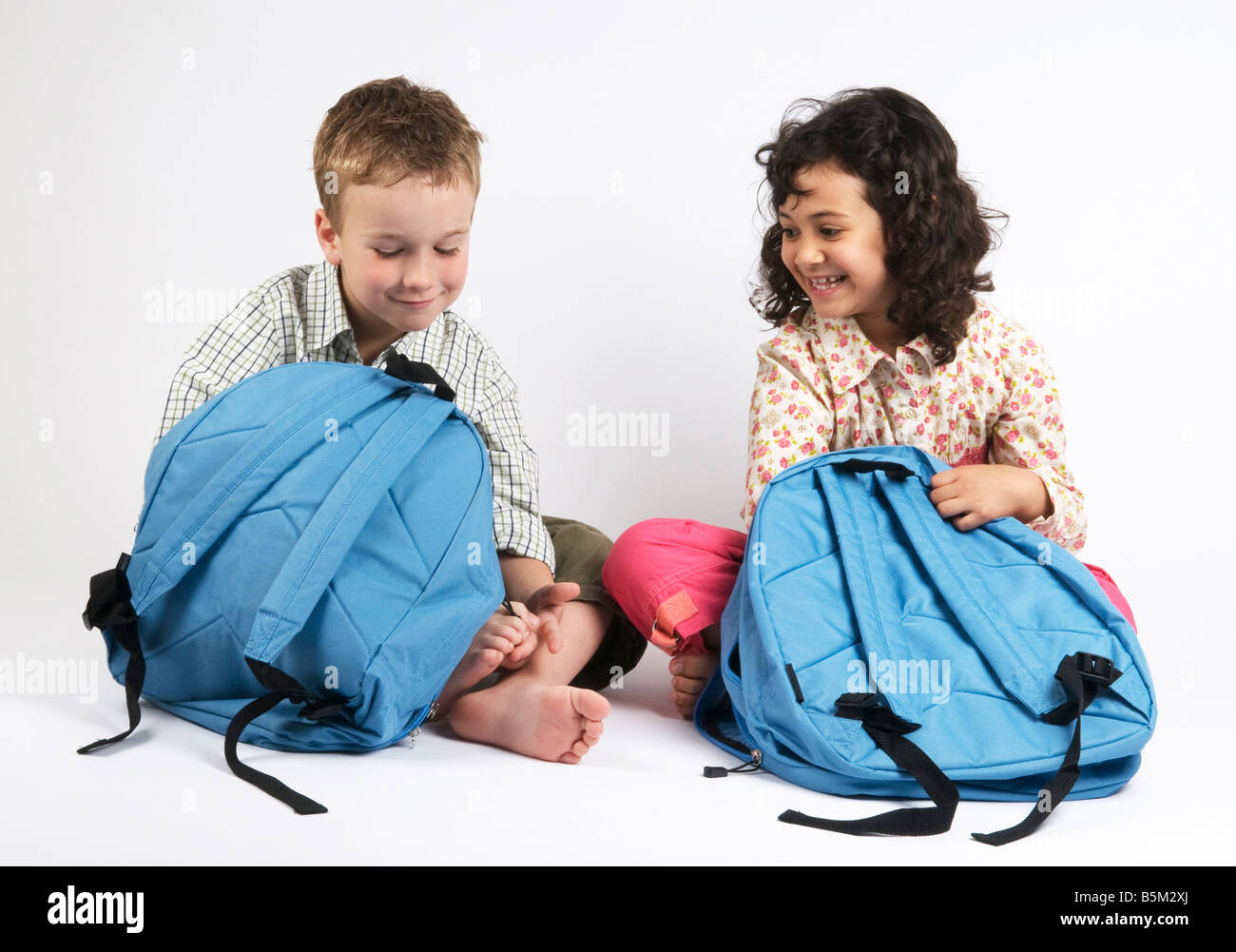 Two kids going on a vacation packing their backpacks Or use it as two ...