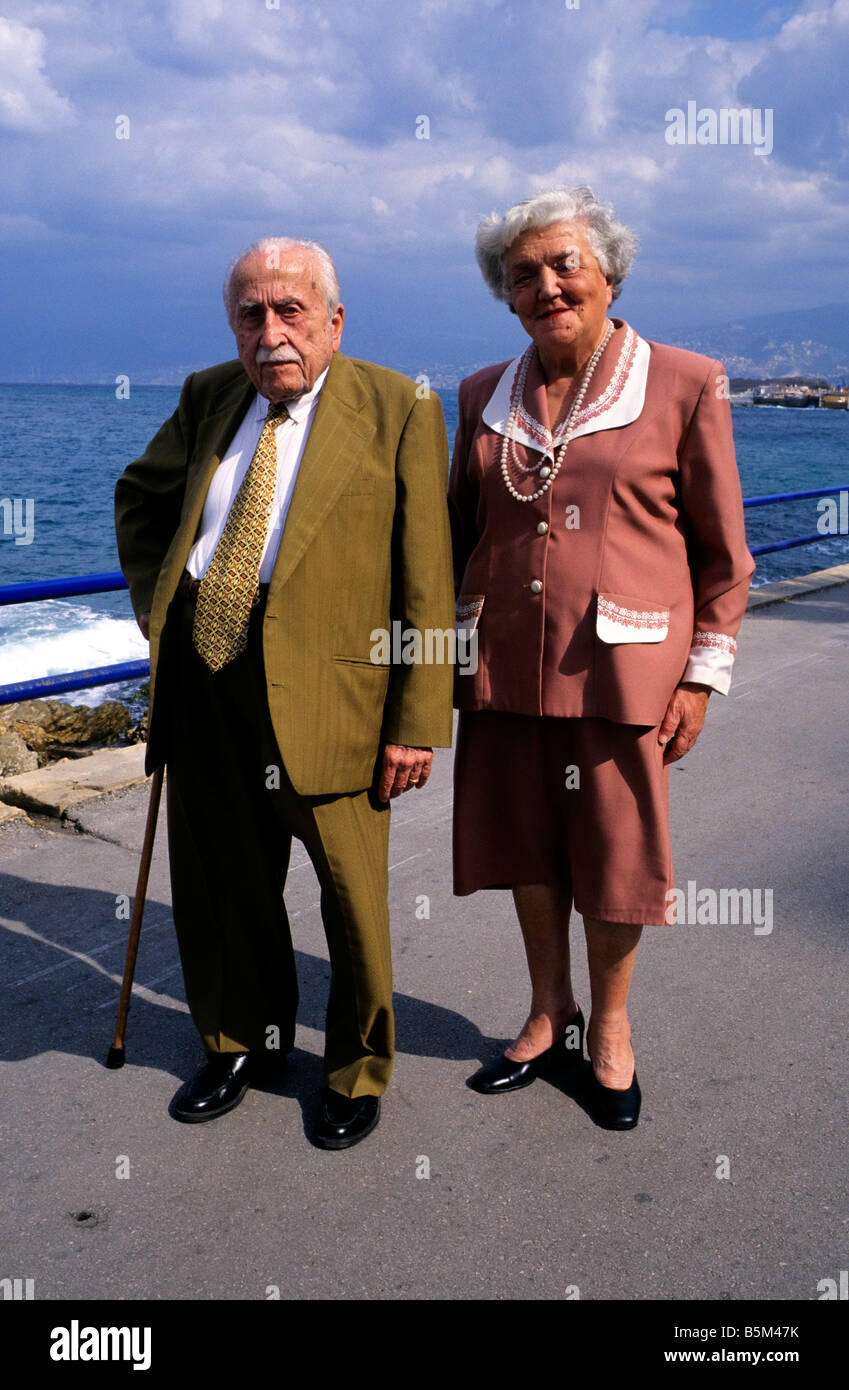 An elderly couple, smartly dressed in clothing that looks like it's ...