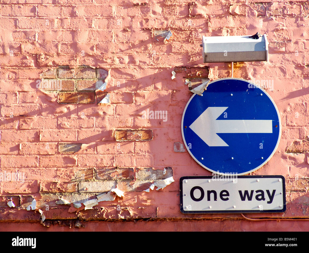 One way Road Sign on Dilapidated Pink Wall Stock Photo - Alamy