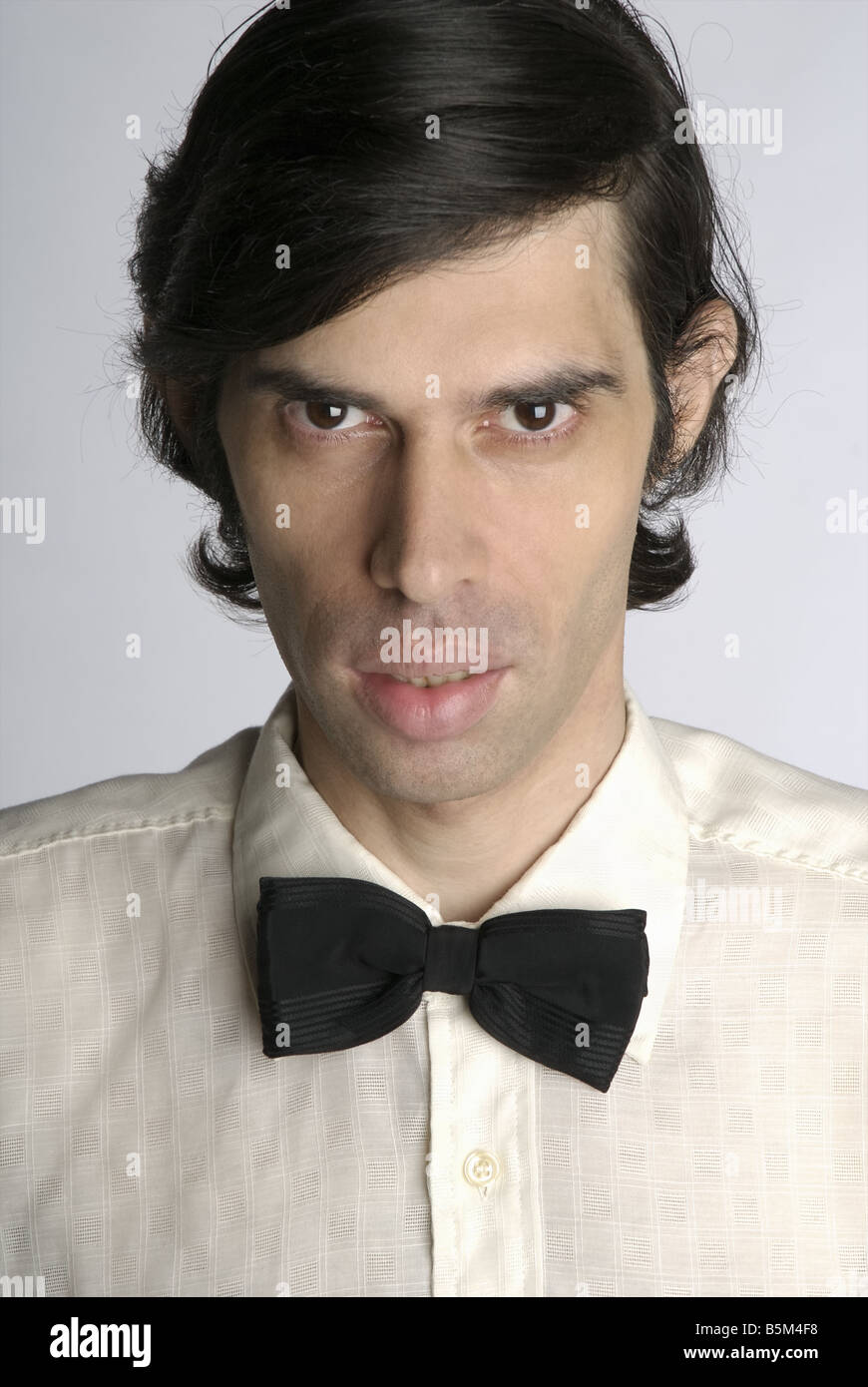 Portrait of a young man with a bow tie Stock Photo - Alamy