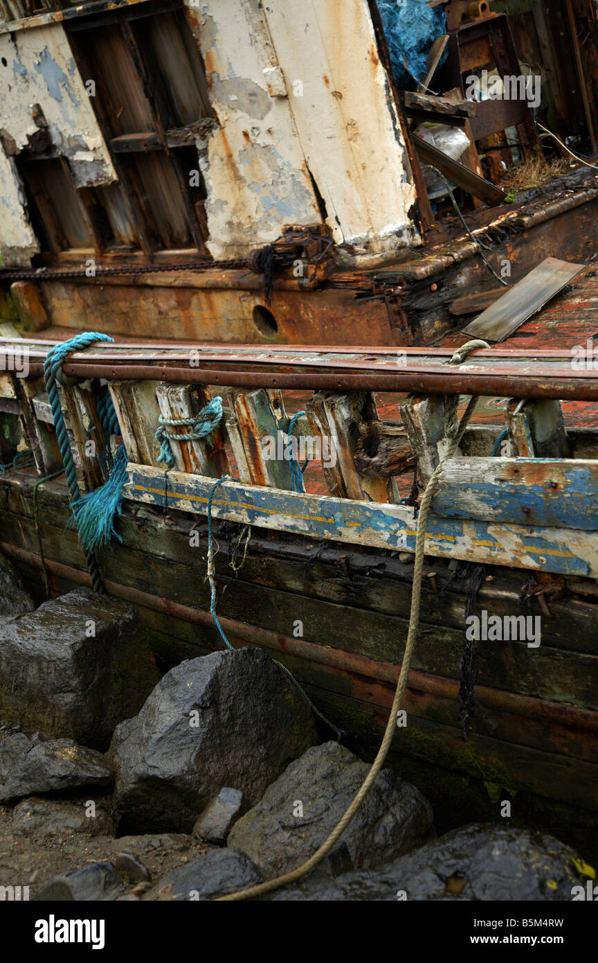 close up of the rotting hull of abandoned blue fishing boat on the ...