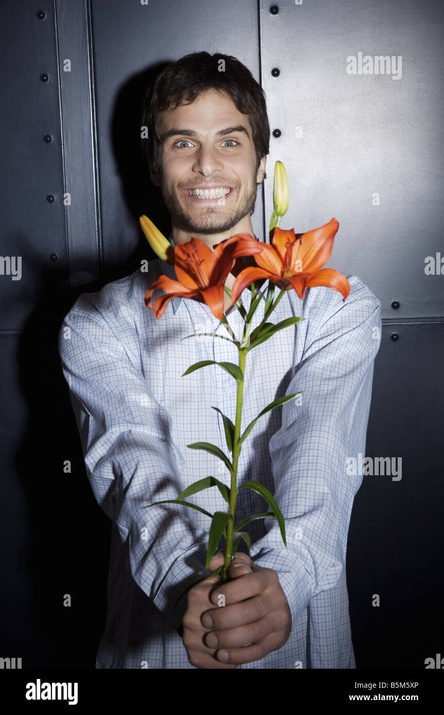 Young man holding flowers Stock Photo - Alamy