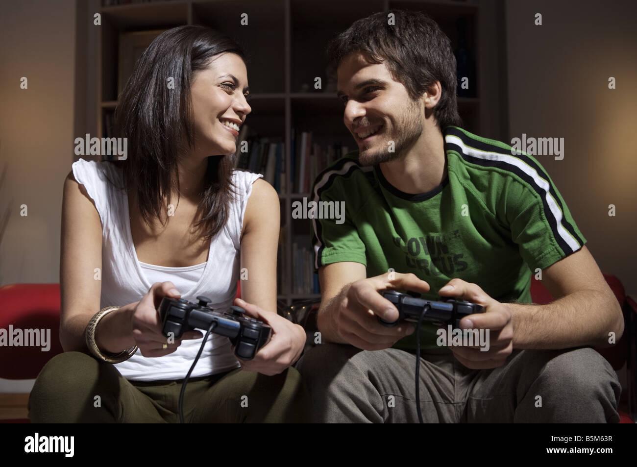 Couple playing with video game Stock Photo - Alamy