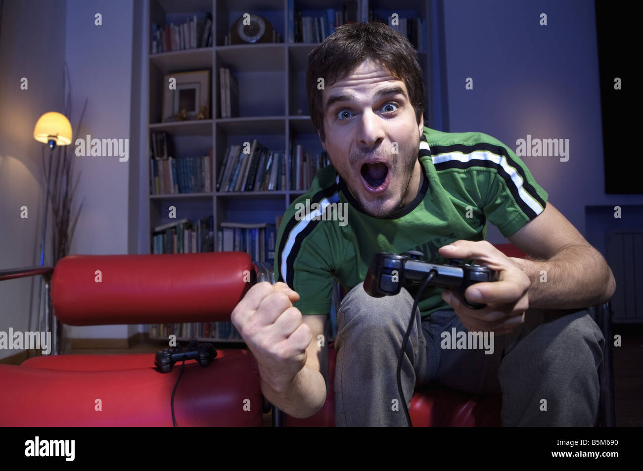 Young man playing with video game Stock Photo - Alamy