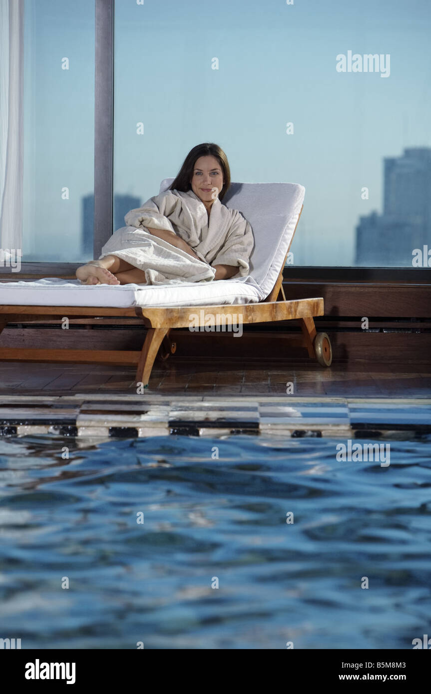 One woman lounging at the pool Stock Photo - Alamy