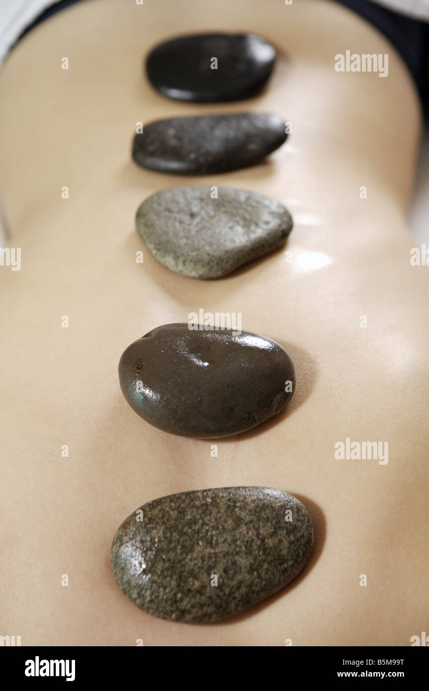 Woman receiving a stone massage Stock Photo - Alamy