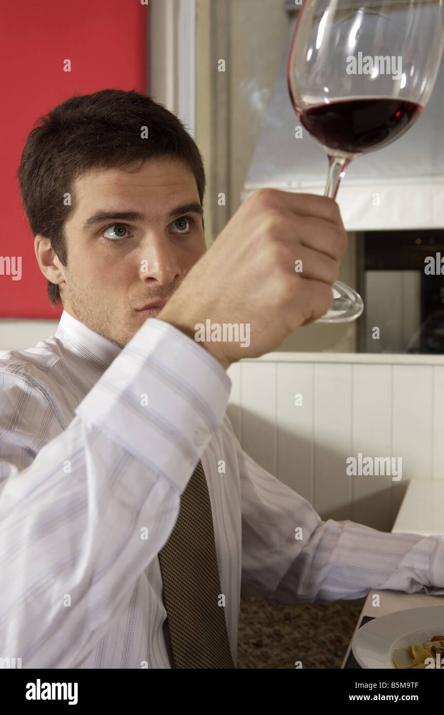 Man checking wine for clarity and color Stock Photo - Alamy