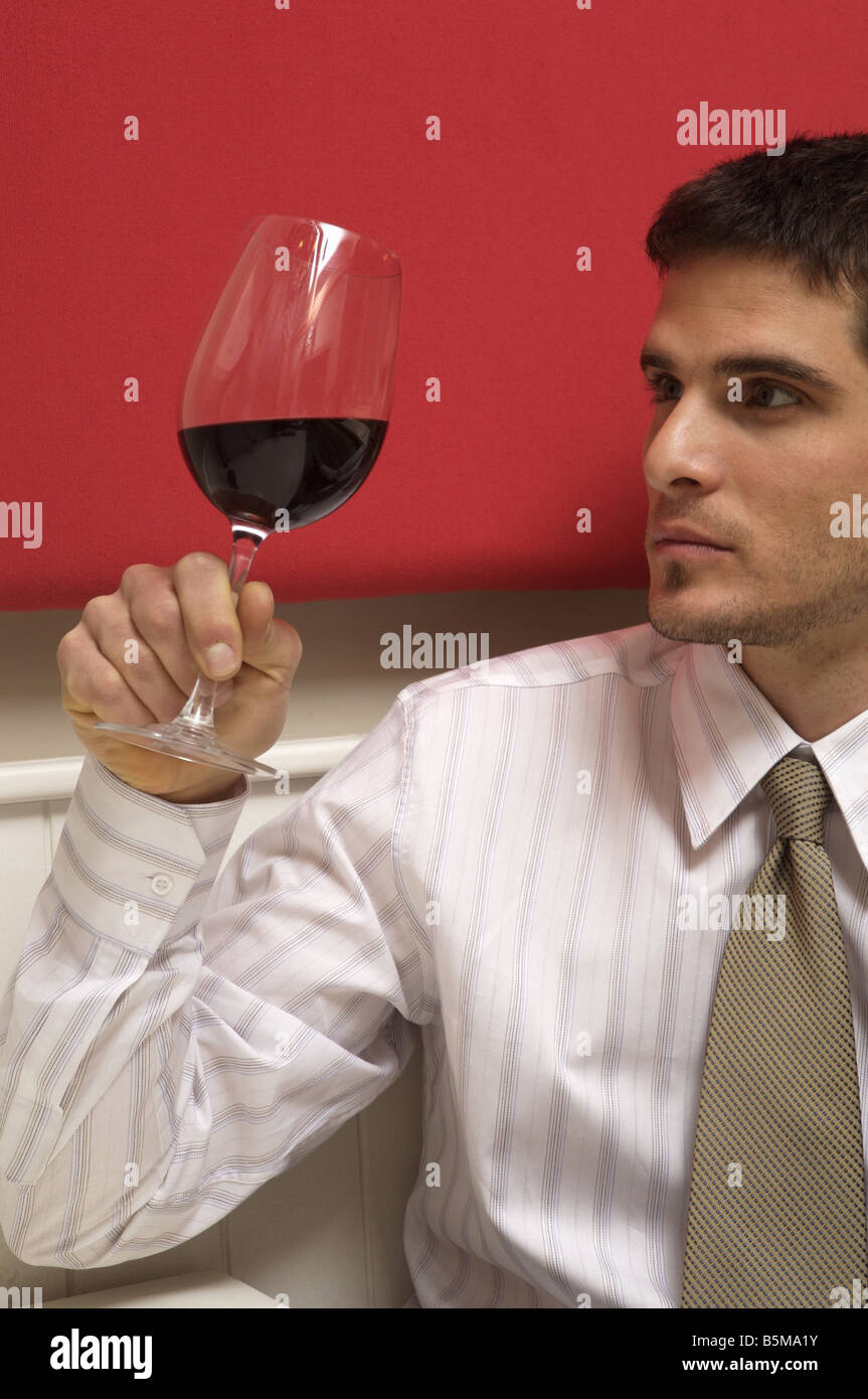 Man checking wine for clarity and color Stock Photo - Alamy
