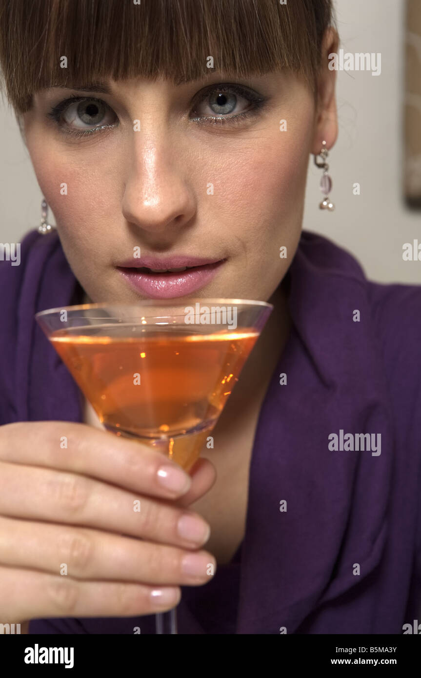 A woman drinking a martini Stock Photo - Alamy